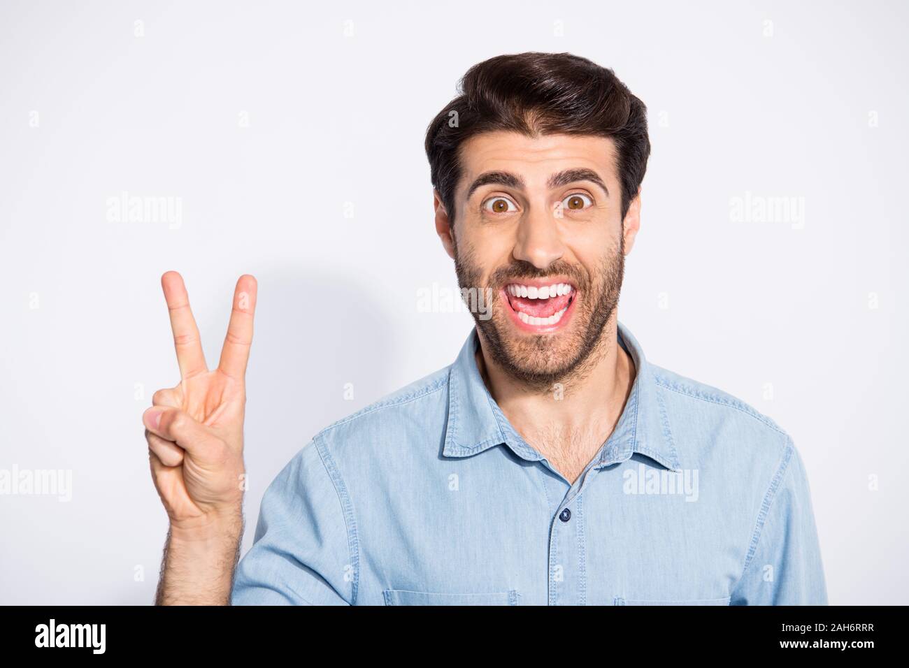 Close up photo of amazing handsome guy showing v-sign symbol greets ...