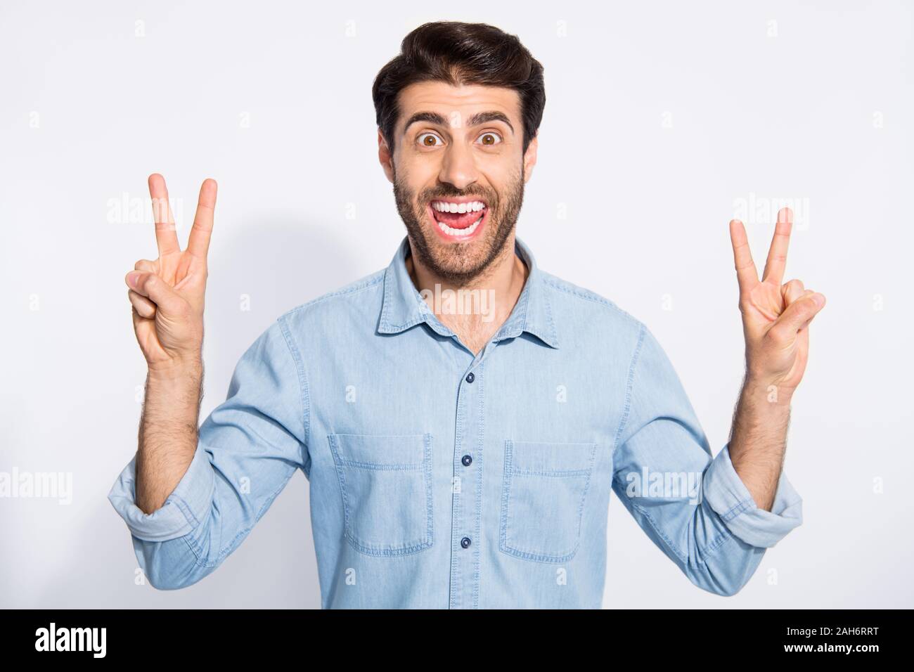 Photo of amazing handsome guy raising arms showing v-sign symbols say ...