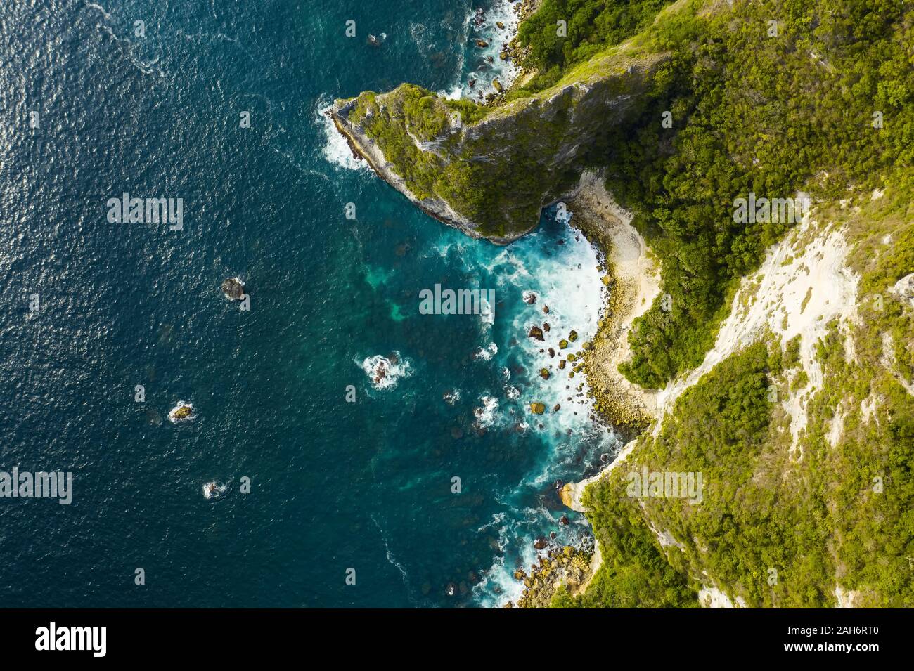 View from above, stunning aerial view of a green limestone cliff bathed ...