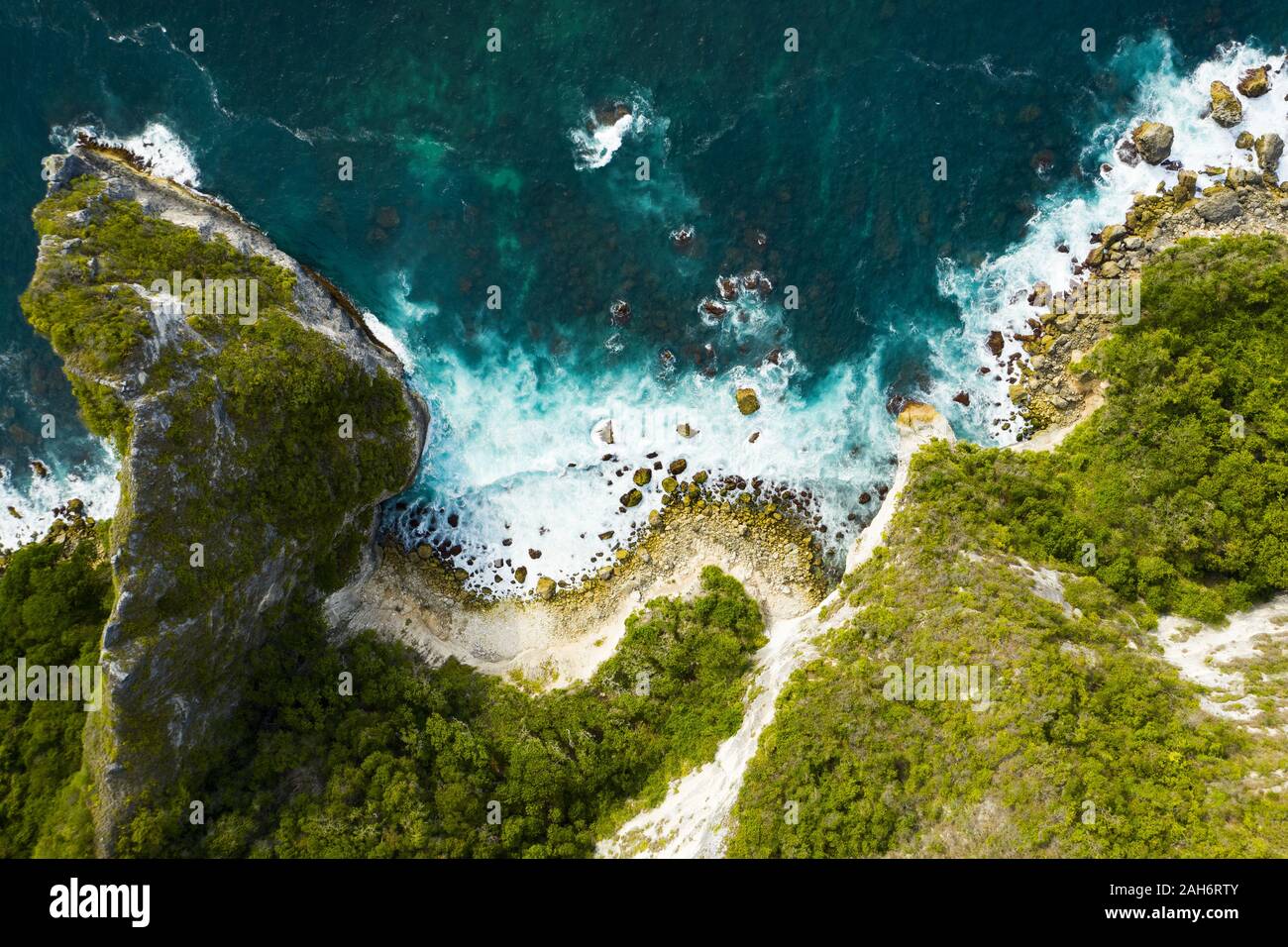 View from above, stunning aerial view of a green limestone cliff bathed ...