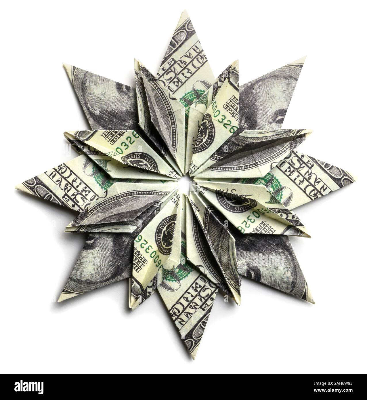 A 100 dollar bill in the shape of a snowflake on a white background ...
