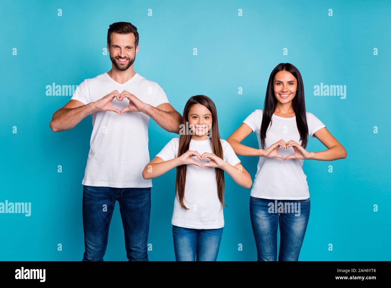 Portrait of charming family with brunette haircut making heart sign ...