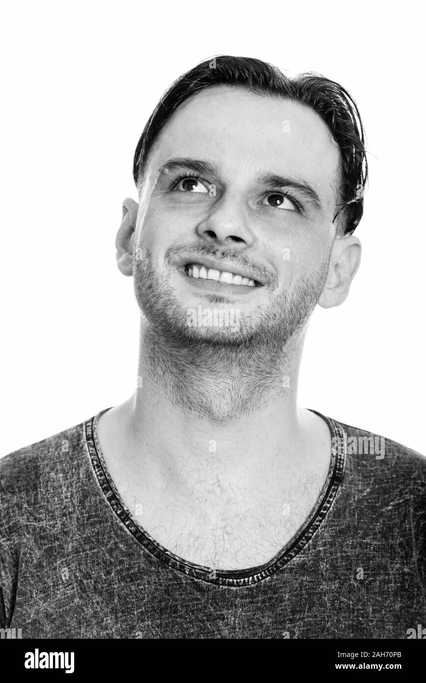 Face of young happy man smiling while thinking Stock Photo - Alamy