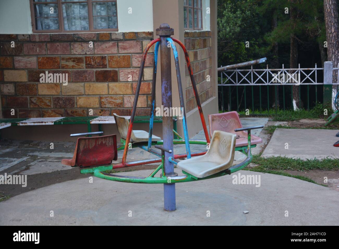 Close up of a Merry go round made of steel pipes and plastic chairs in ...