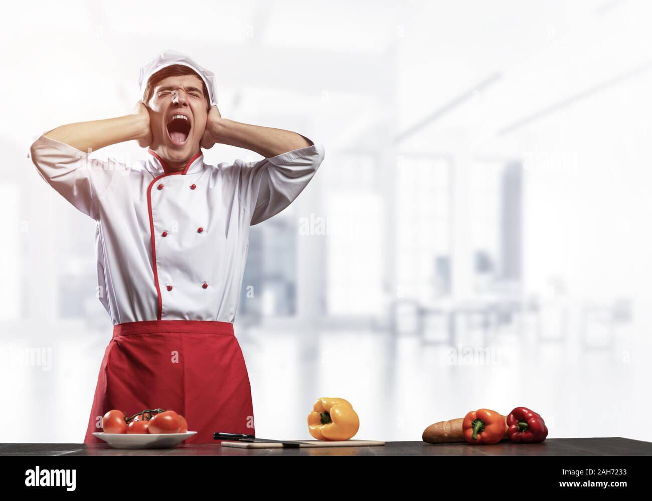Young male chef screaming in shock and horror. Emotional caucasian chef ...