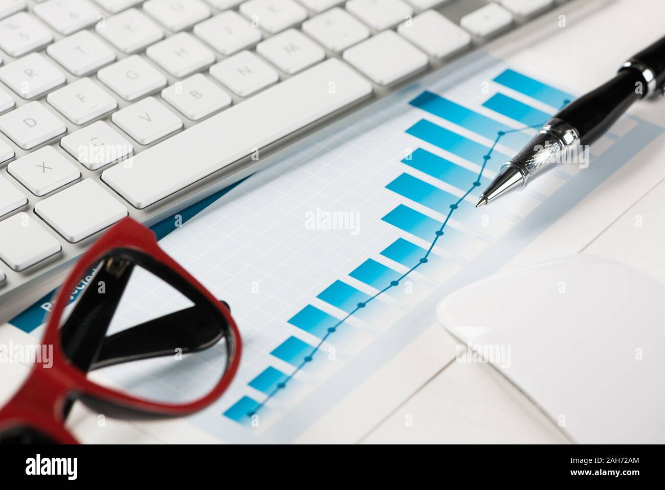 Business workplace with keyboard mouse and papers with graphs and ...