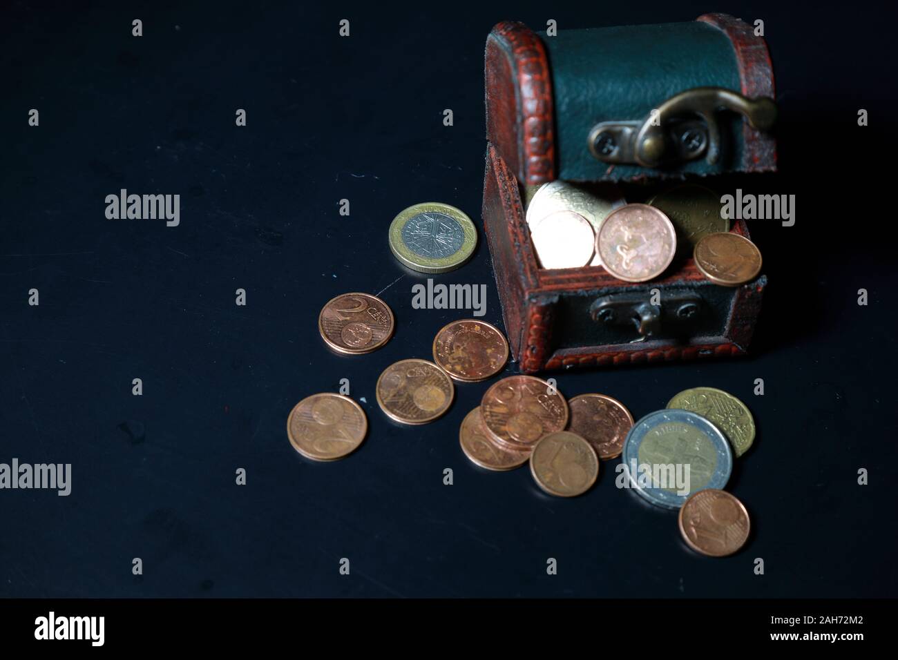chest with coins on a dark background Stock Photo - Alamy