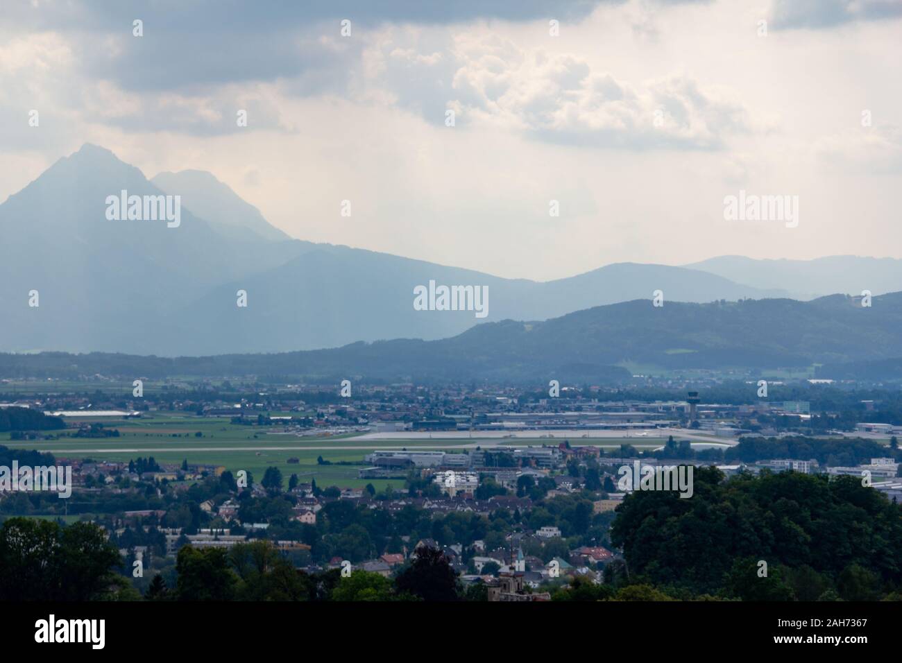 A foggy aerial view over Salzburg airport and the Austrian alps in the ...
