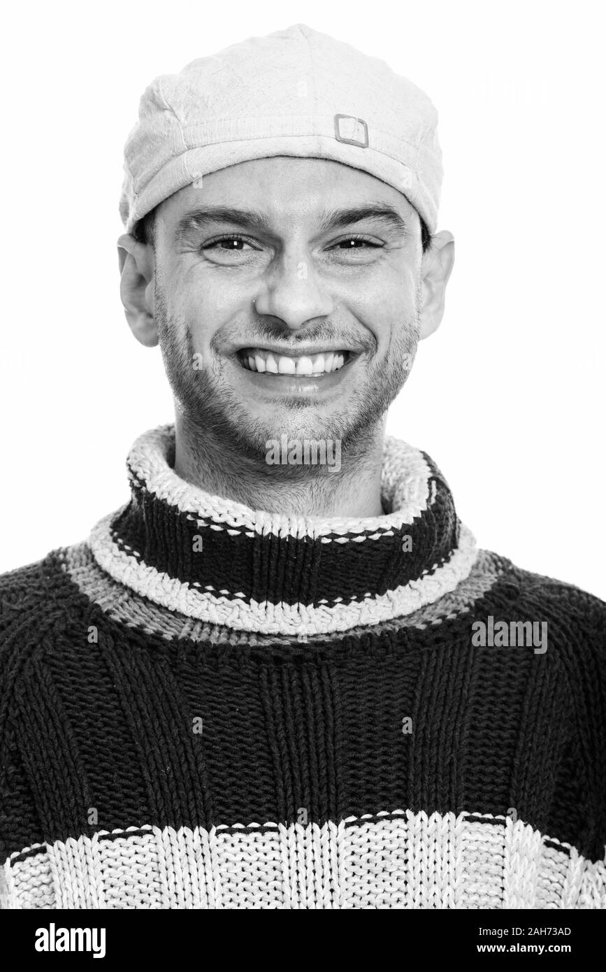 Face of young happy man smiling while wearing hat Stock Photo - Alamy