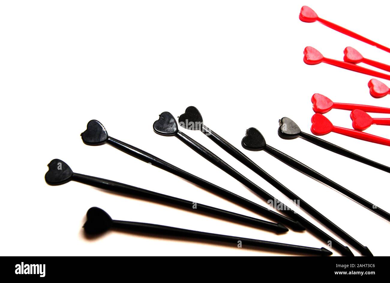 Black and red sticks for canapes on a white isolated background ...