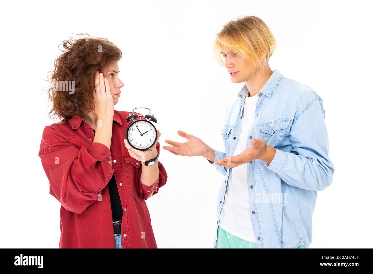 couple in love with alarm clock argues about time isolated on white ...