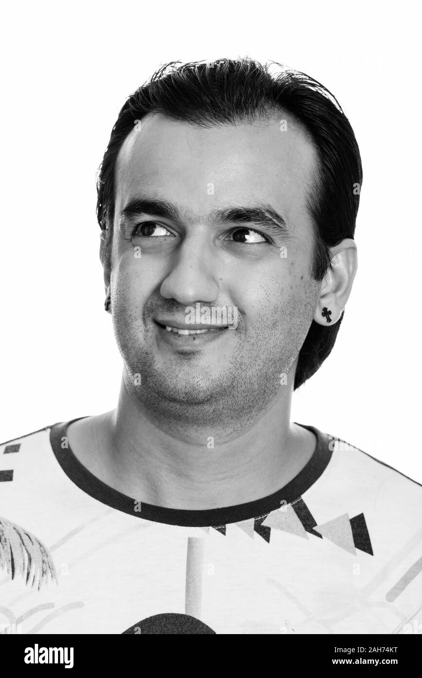 Face of happy Persian man smiling and thinking while looking up Stock ...