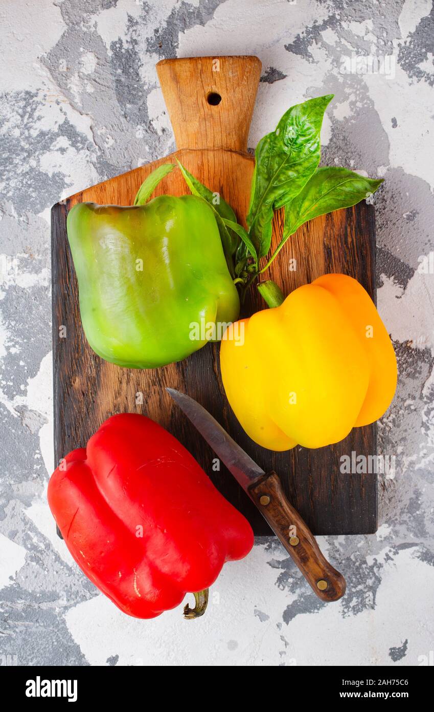 color peppers on wooden board on a table Stock Photo - Alamy