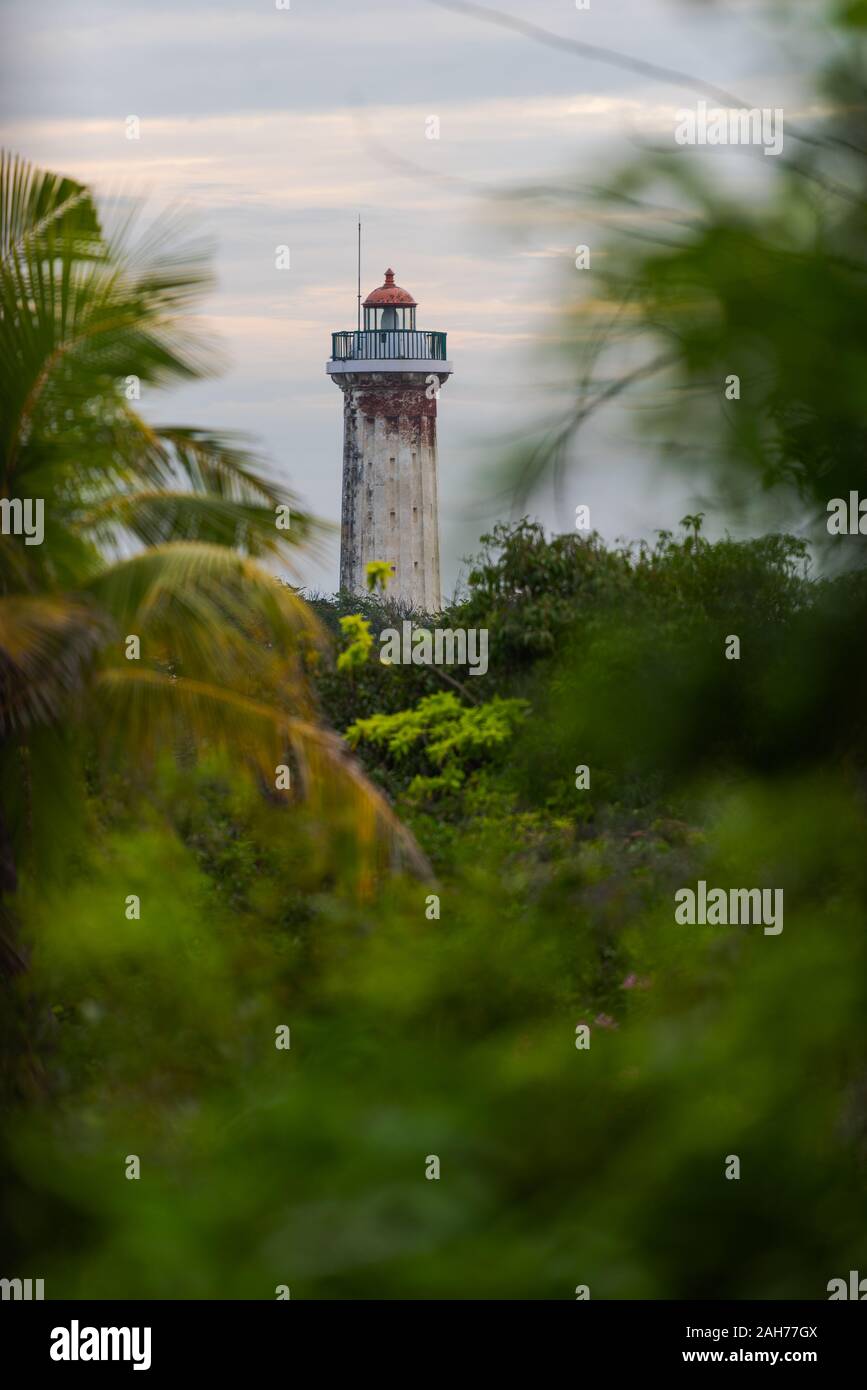 The old lighthouse of Puducherry, South India seen through a group of ...