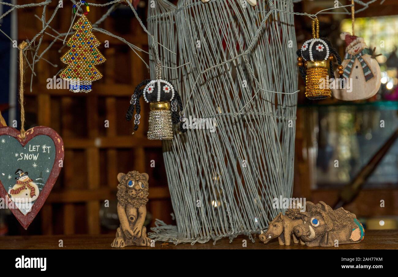 Under a traditional African handcrafted wire art Christmas tree image ...