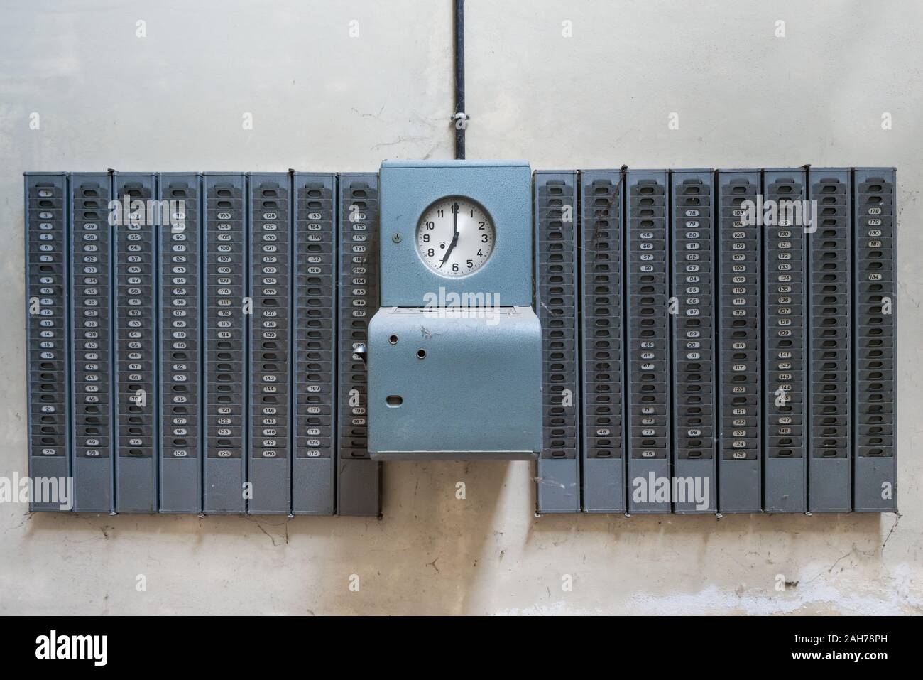 Symmetrical shot of an old mechanical timeclock found in an abandoned ...