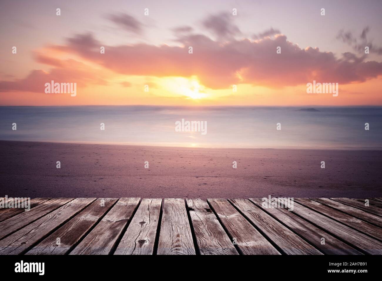 Colorful beautiful cloudy sunset over ocean with wooden path on ...