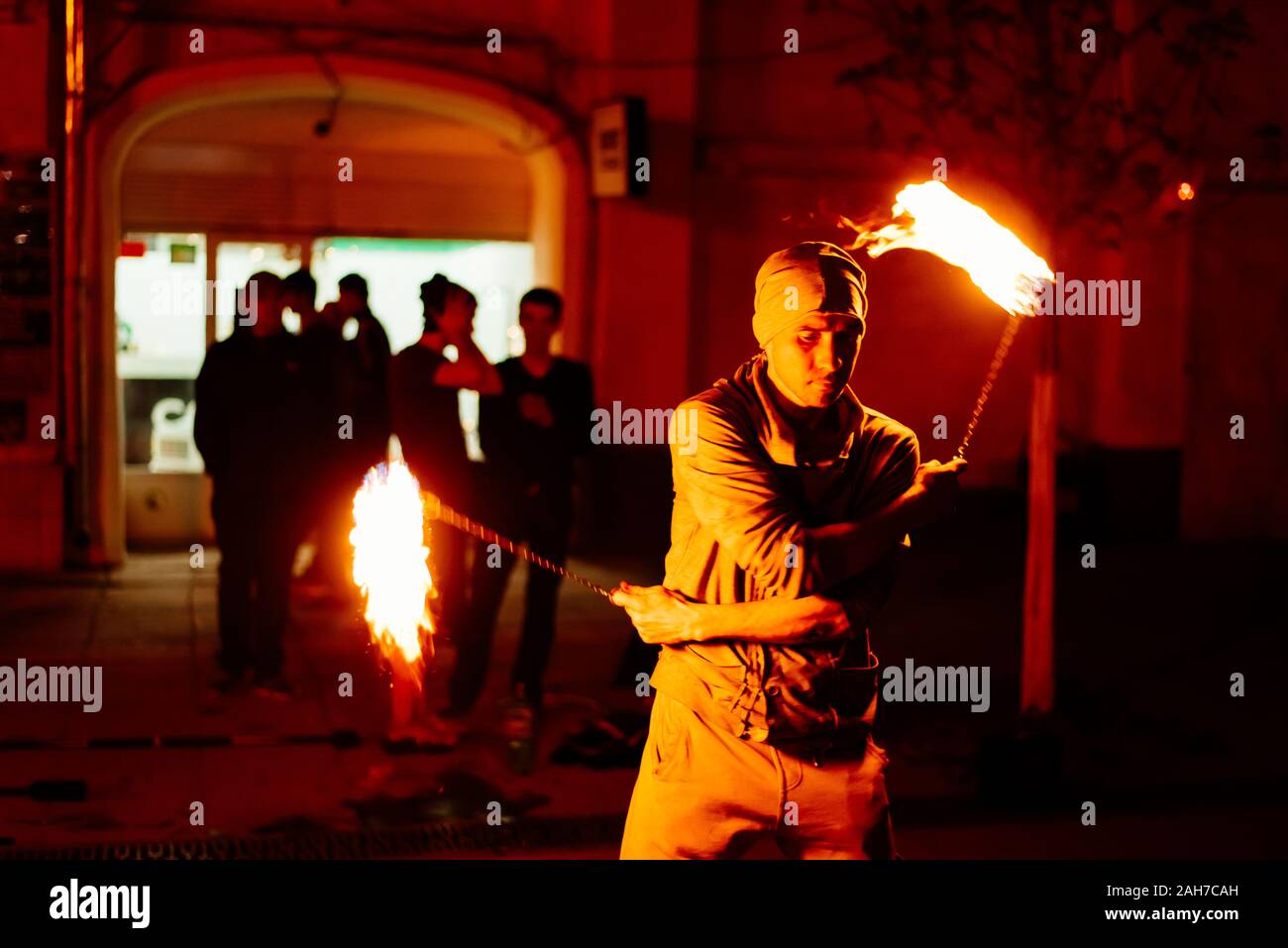 The guy on the street turns a torch of fire Stock Photo - Alamy