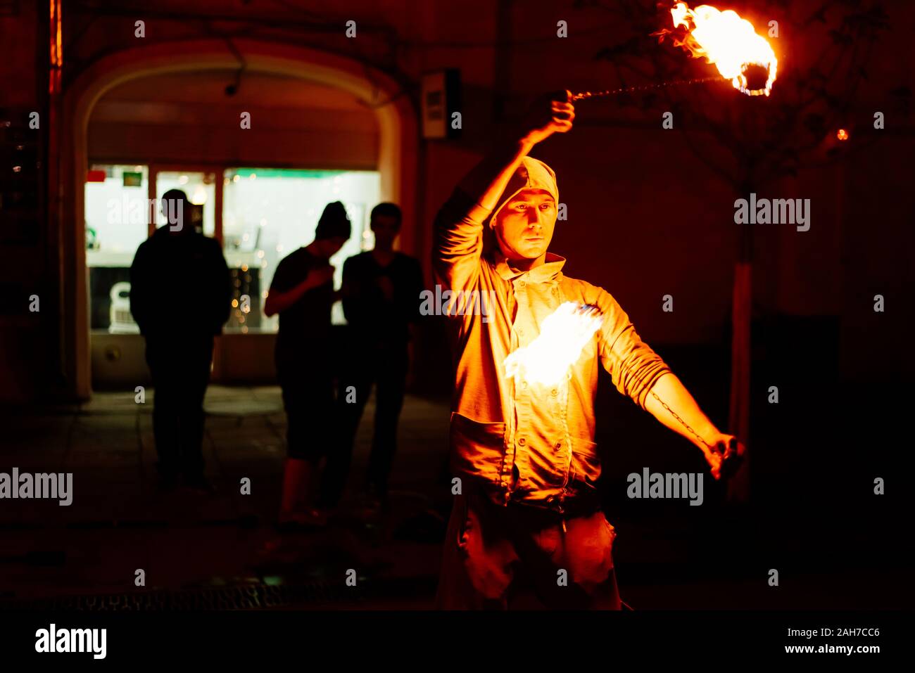 The guy on the street turns a torch of fire Stock Photo - Alamy