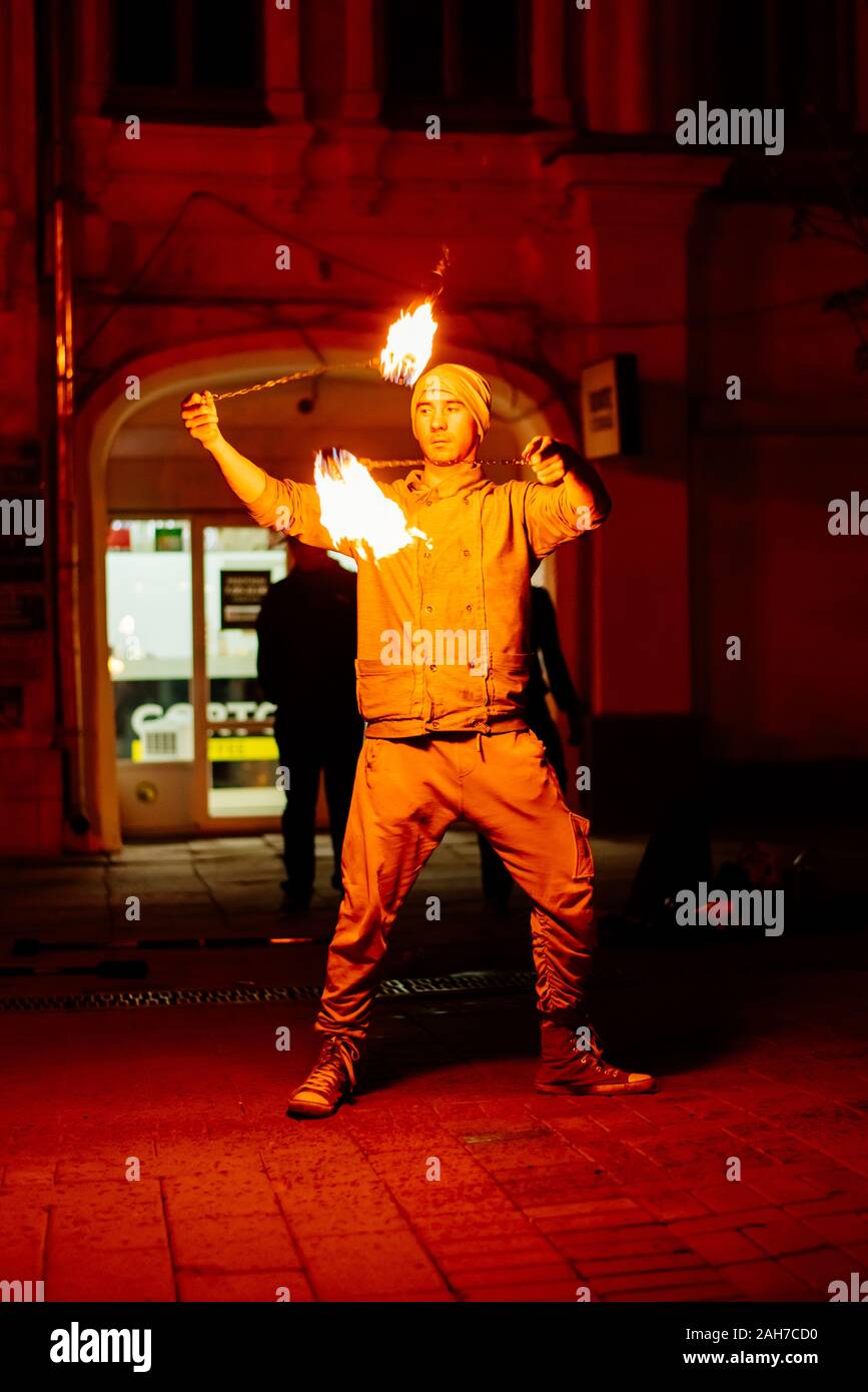 The guy on the street turns a torch of fire Stock Photo - Alamy