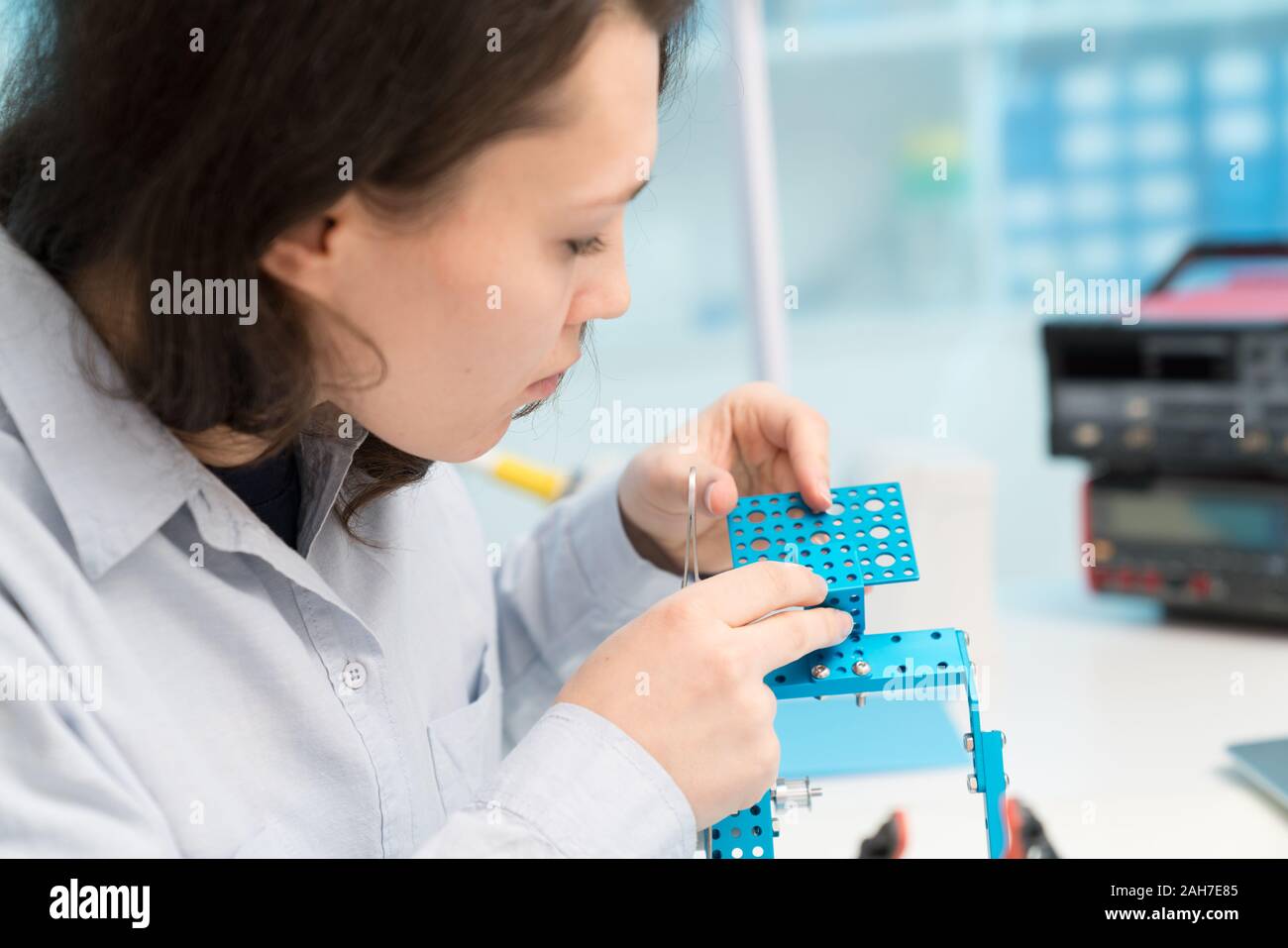 Student woman in robotics laboratory working on project mechatronics ...