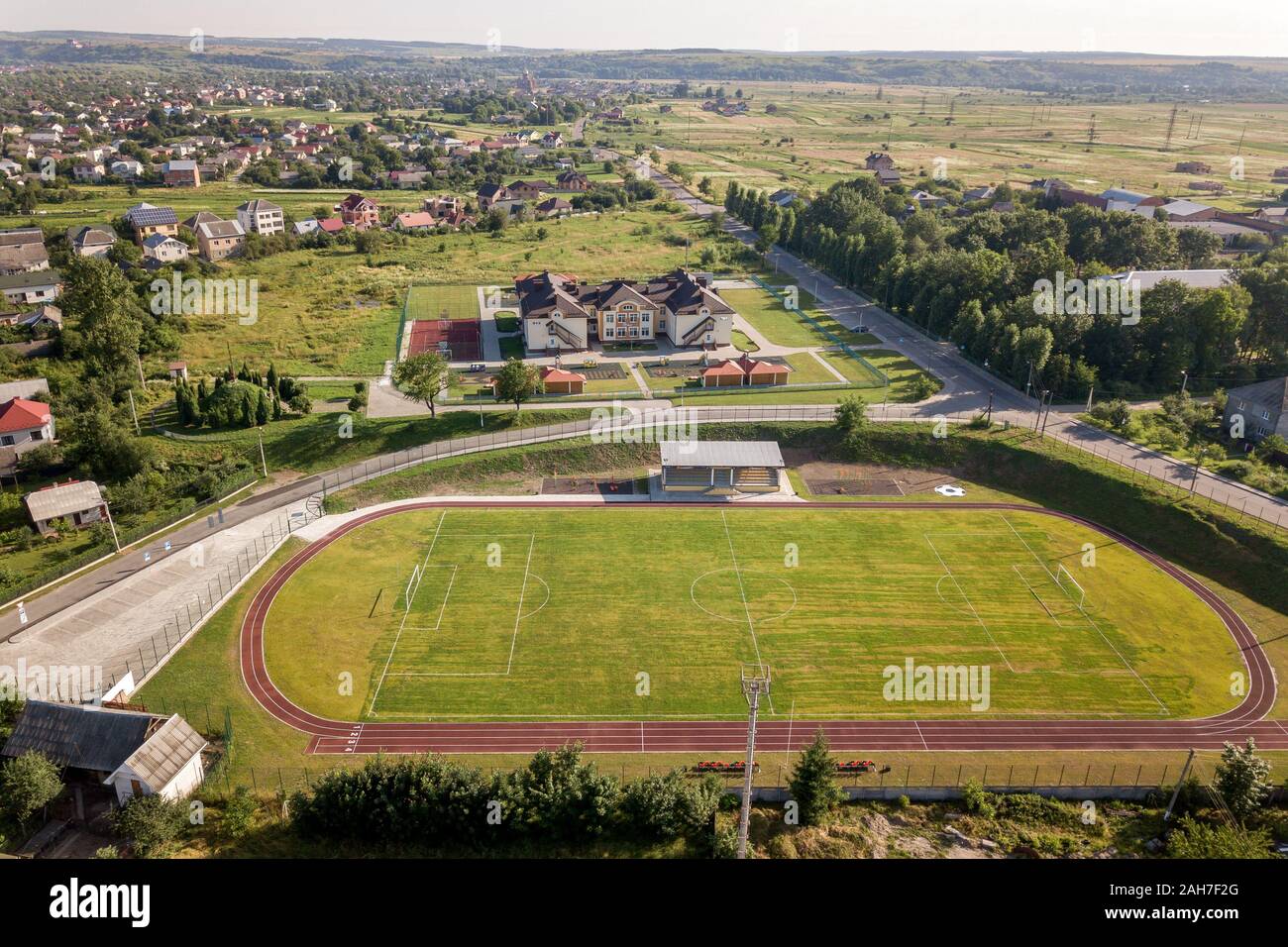 Aerial view of a football field on a stadium covered with green grass ...