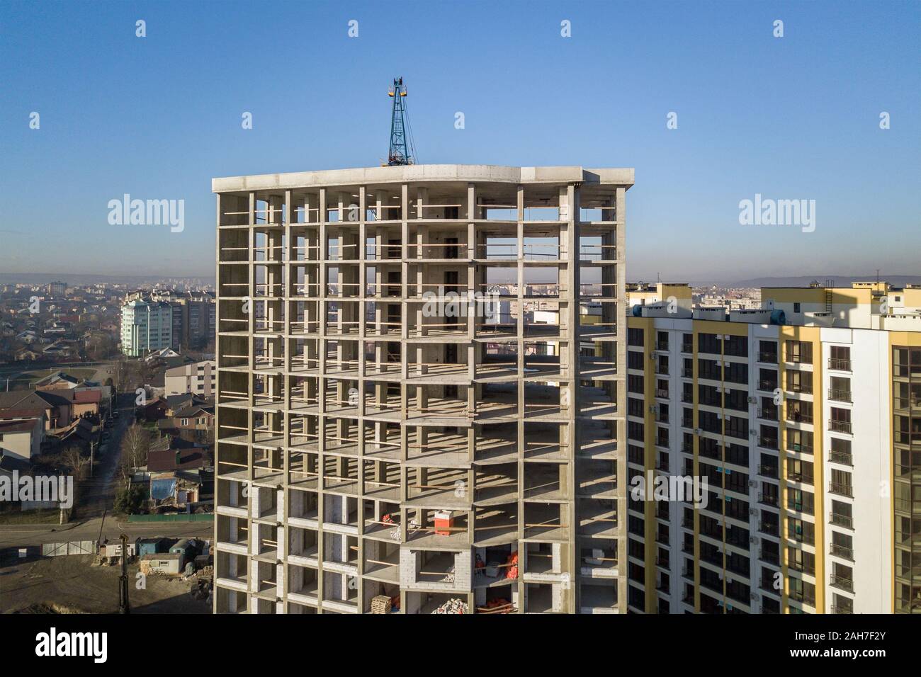Aerial view of concrete frame of tall apartment building under ...