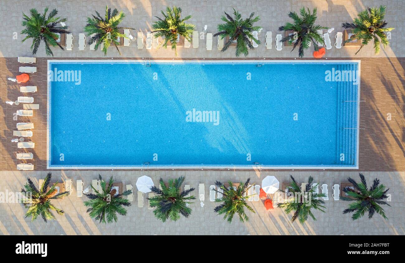Top down aerial view of hotel swimming pool with crystal blue water ...