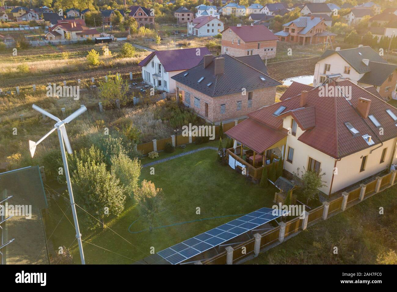 Aerial view of a residential private house with solar panels on roof ...
