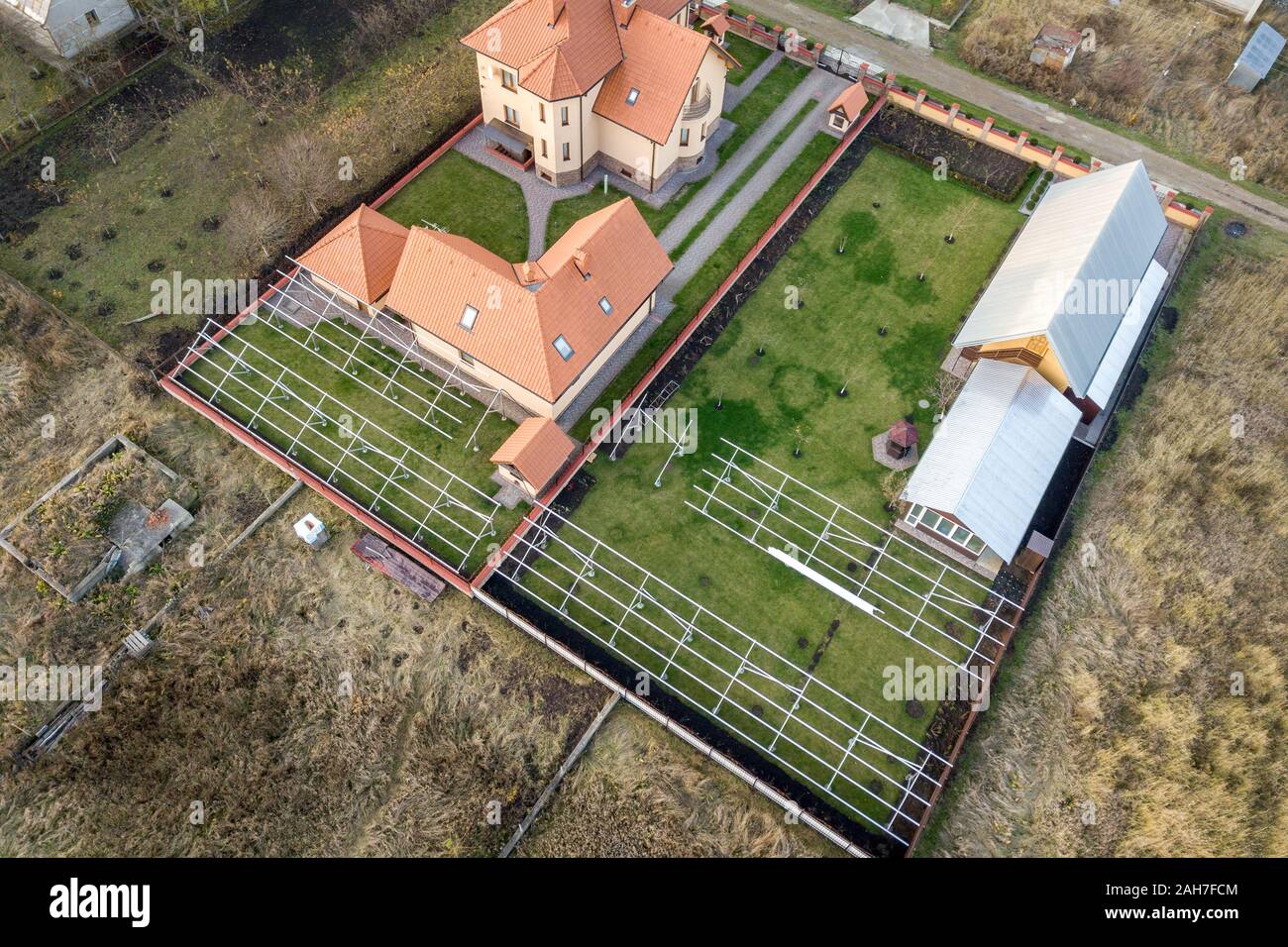 Top down aerial view of a private house with red tiled roof and frame ...