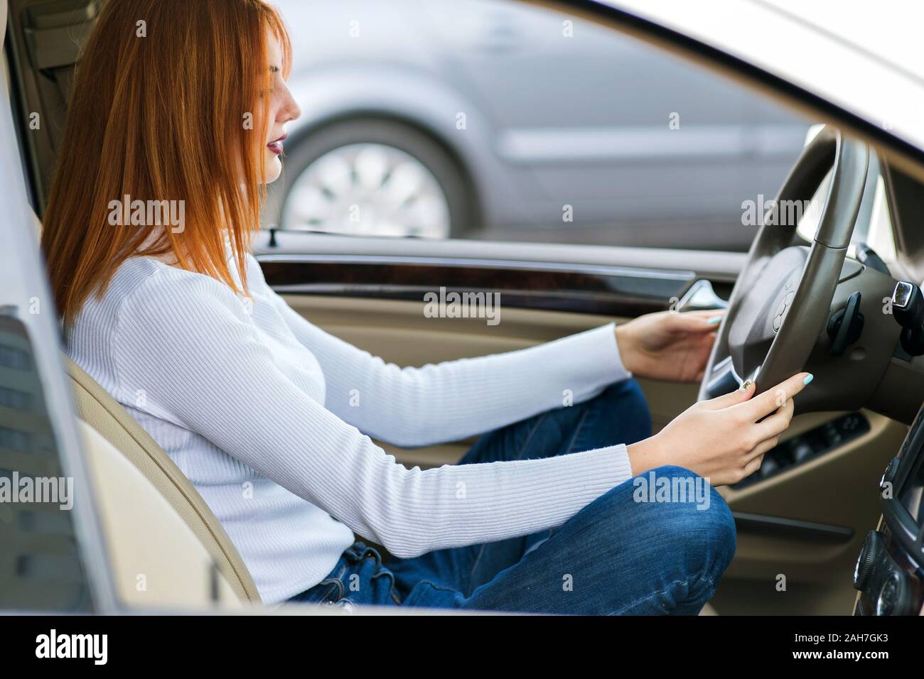 Young woman driver meditating behind a wheel of a car Stock Photo - Alamy