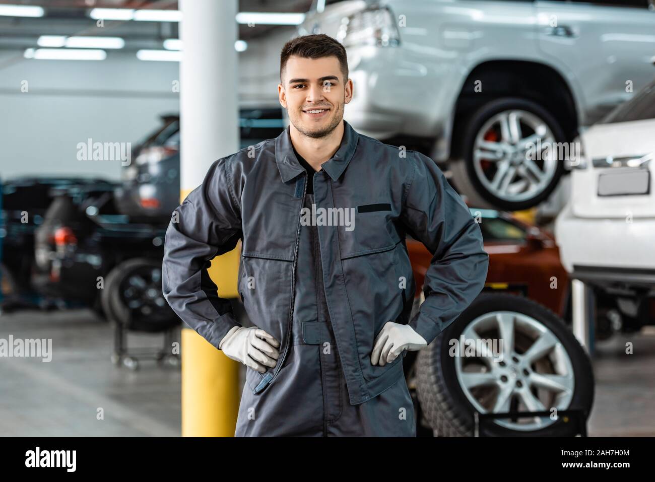Positive handsome young auto mechanic hi-res stock photography and ...