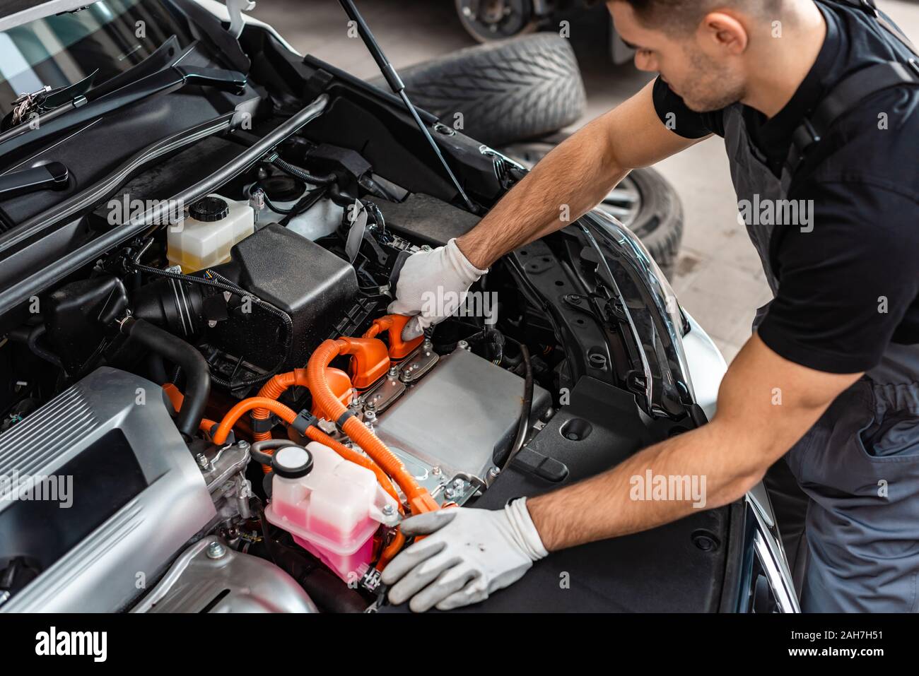 young mechanic inspecting car engine compartment Stock Photo - Alamy