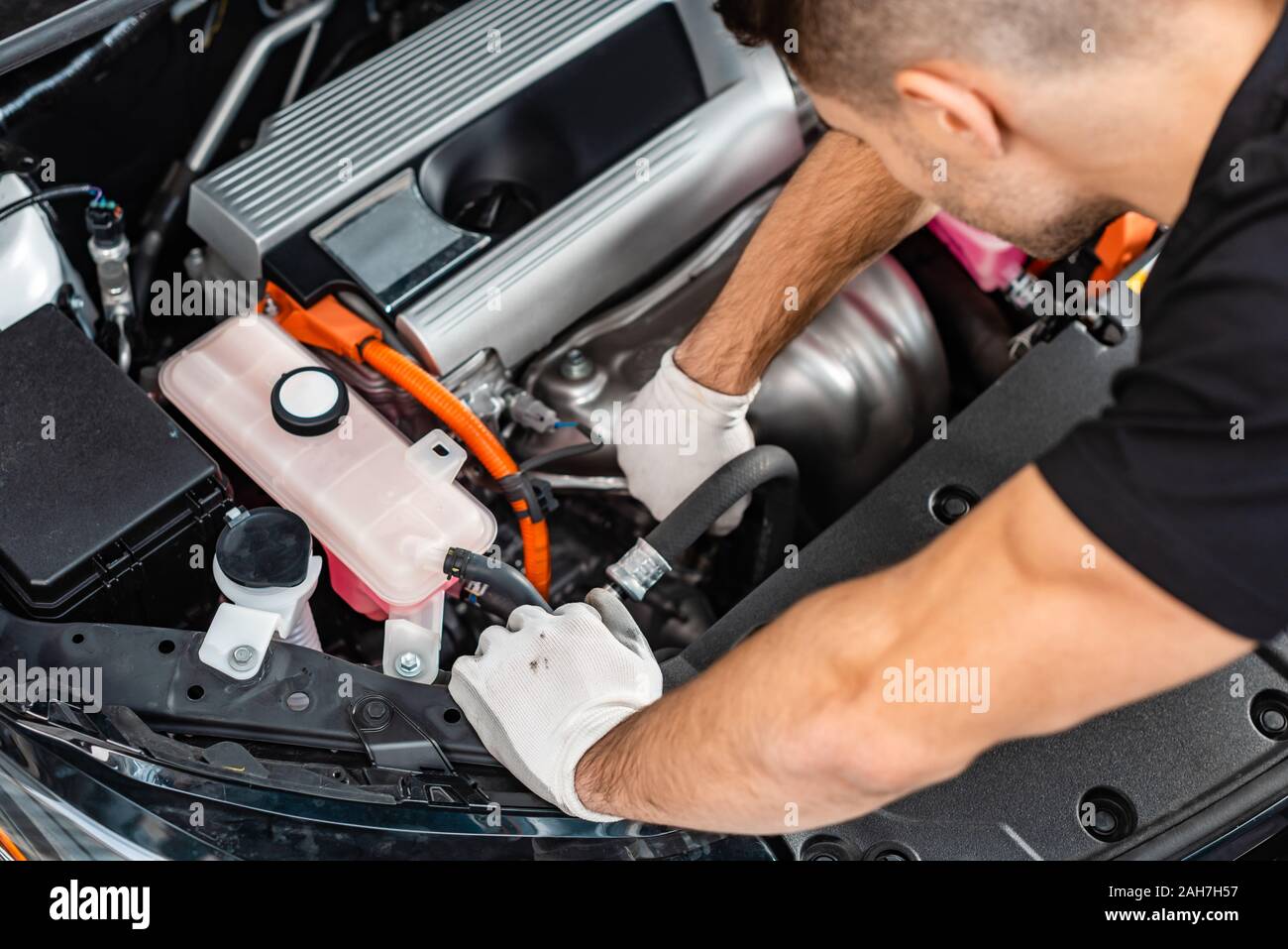 overhead view of young mechanic inspecting car engine compartment Stock ...
