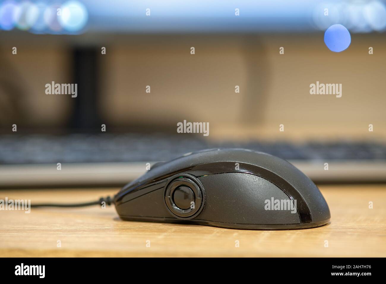 Closeup of a gaming black mouse controller on an empty office desk with ...