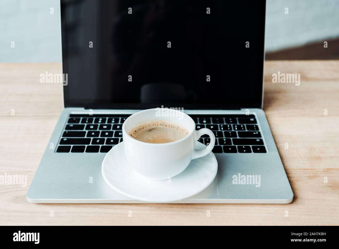 cup of coffee on laptop with blank screen in office Stock Photo - Alamy