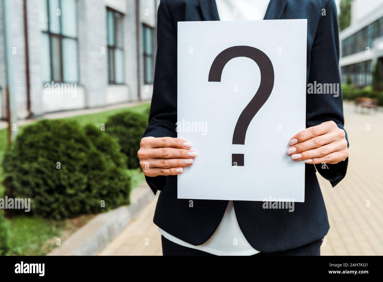 cropped view of woman holding board with question mark outside Stock ...