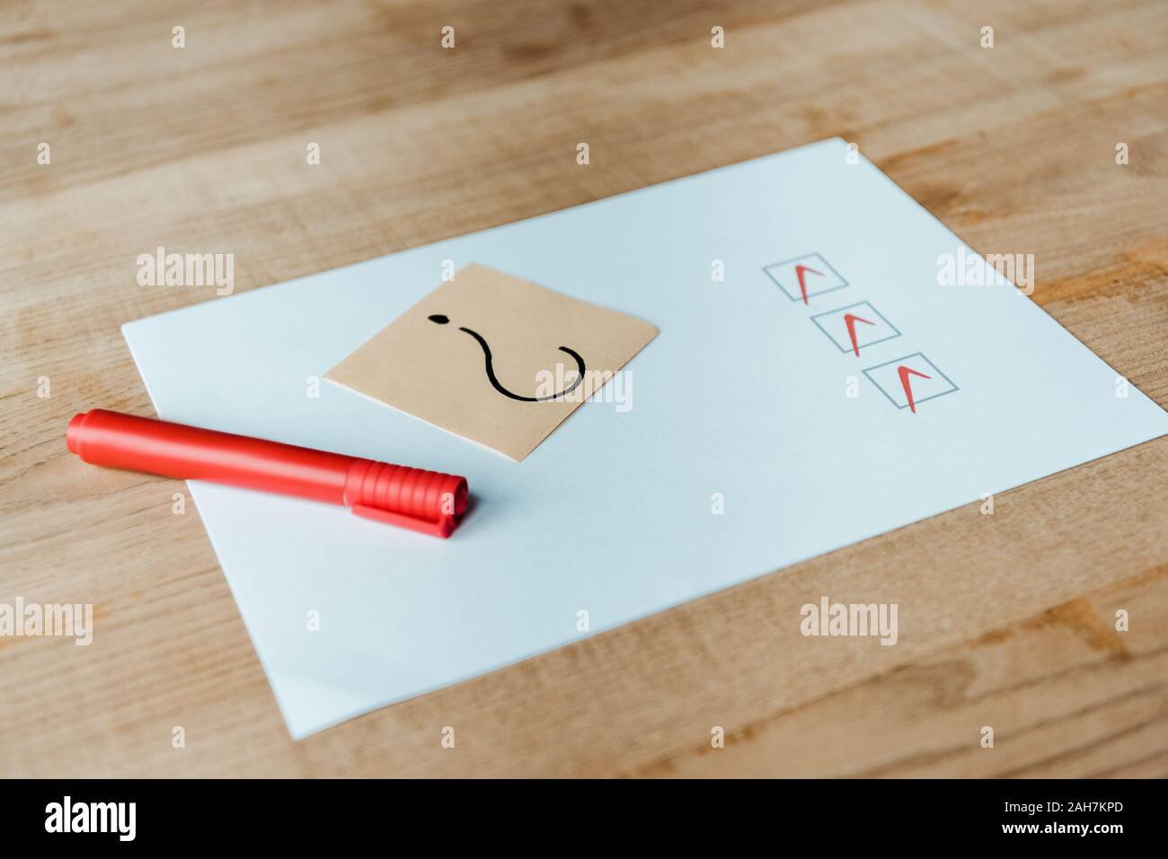 red marker pen near paper with check list and question mark on sticky ...