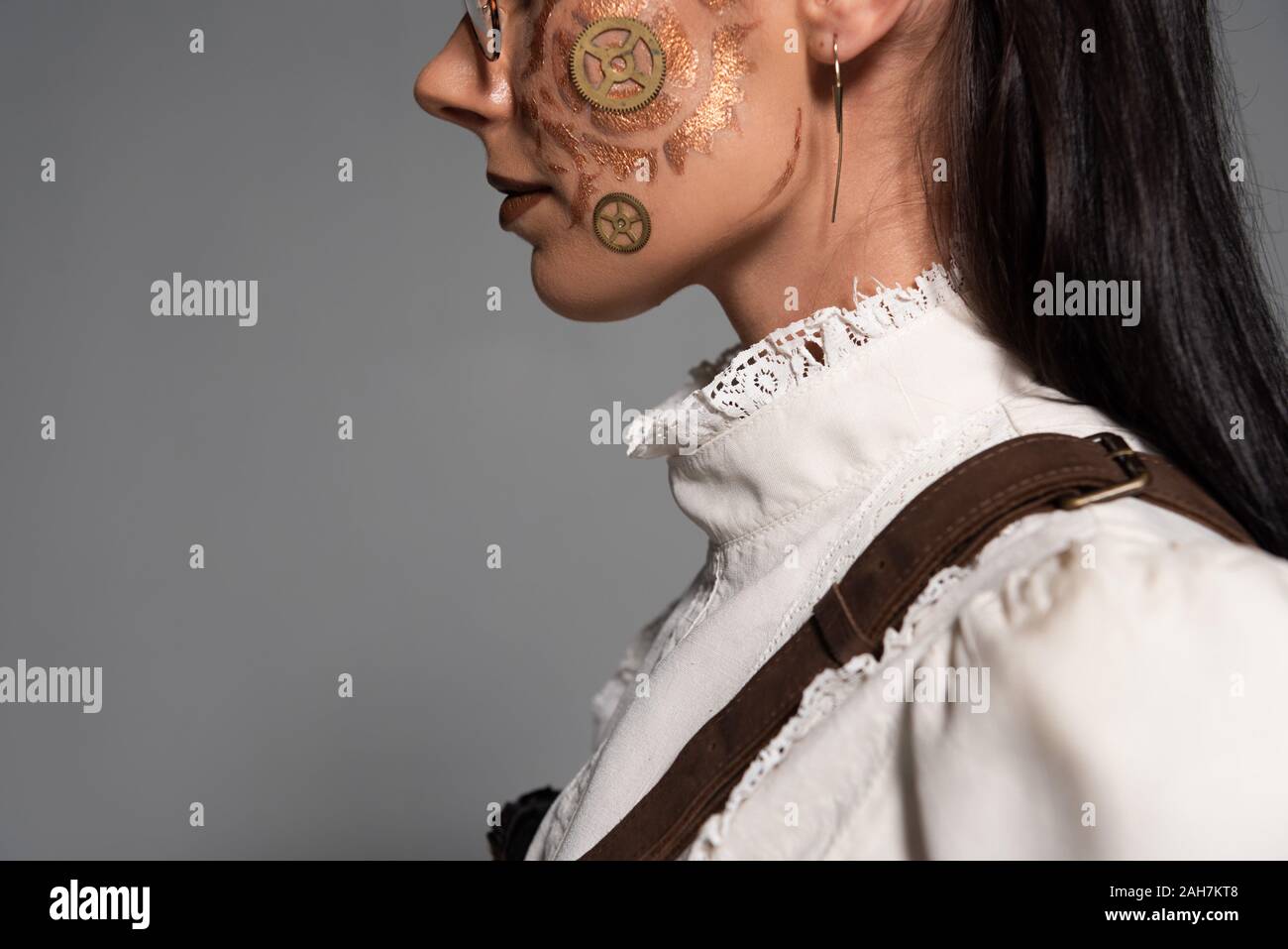 side view of steampunk girl in white blouse with makeup isolated on ...
