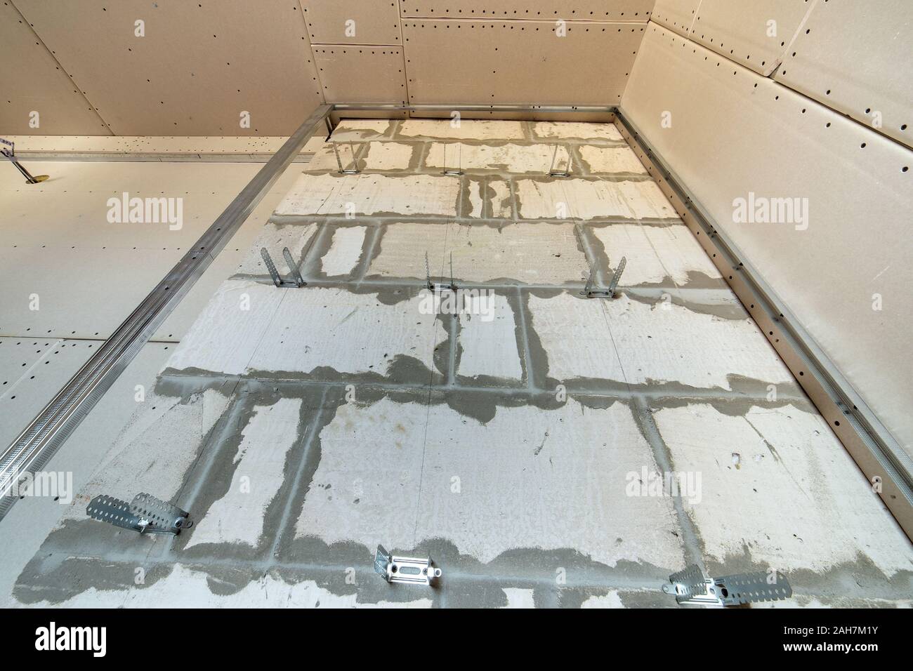 Unfinished brick wall in a room under construction prepared for drywall ...