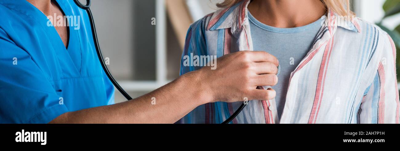 panoramic shot of doctor examining woman with stethoscope Stock Photo ...