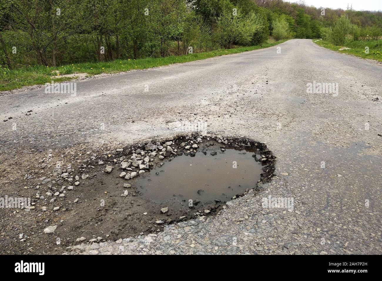 Close up of big pothole with dirty rain water of the road Stock Photo ...