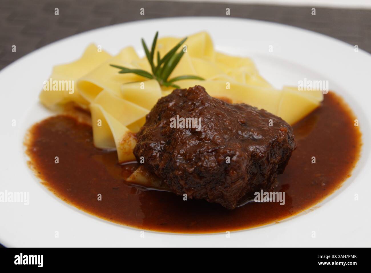 Ox cheeks with noodles Stock Photo - Alamy