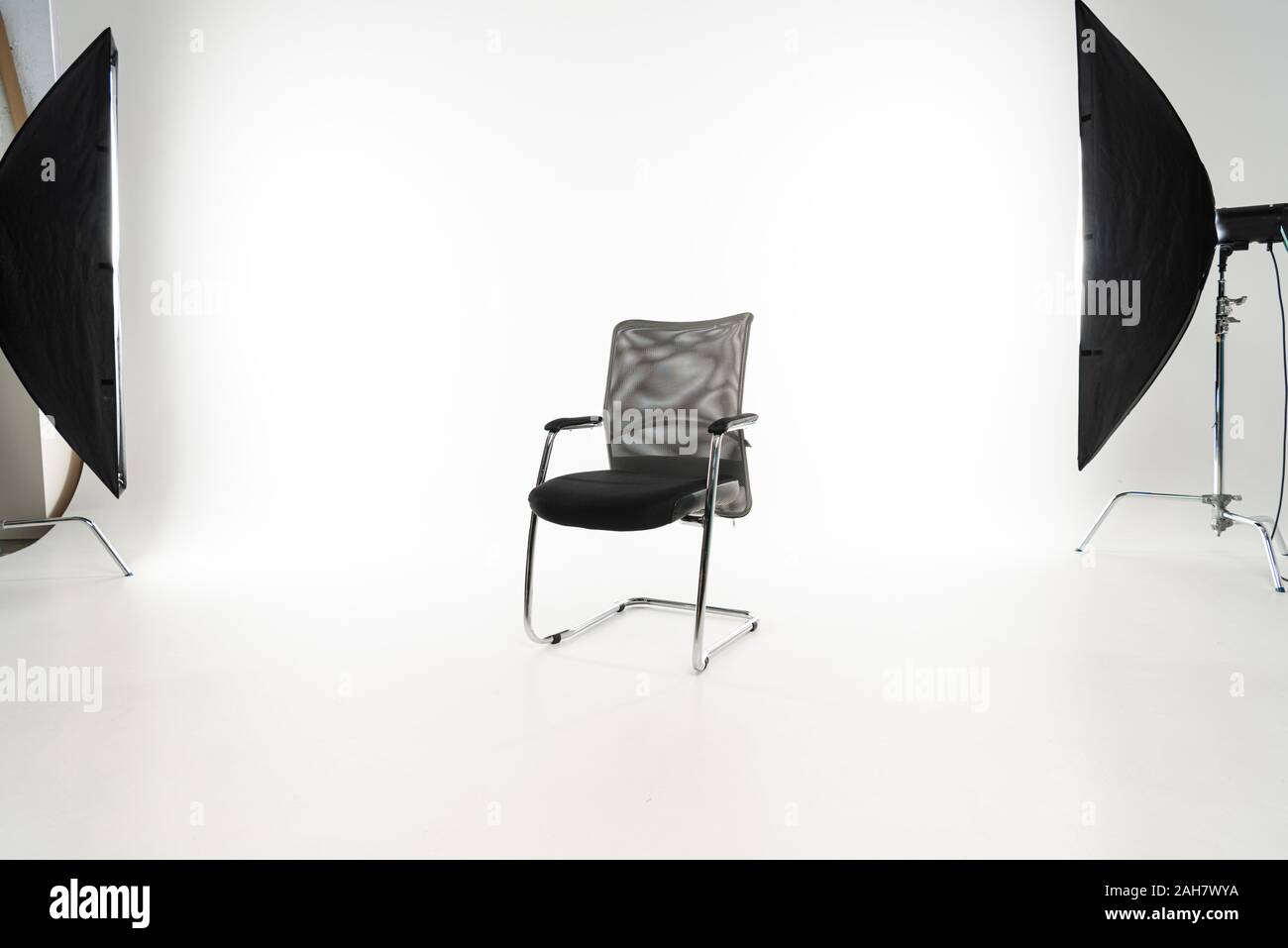 Black modern chair with studio light on white background Stock Photo ...