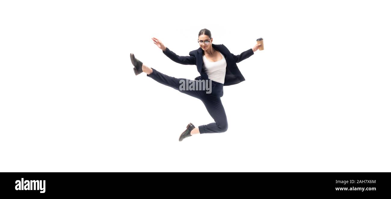panoramic shot of young businesswoman dancing with coffee to go ...