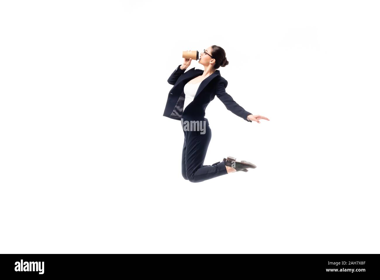 young businesswoman drinking coffee to go while dancing isolated on ...