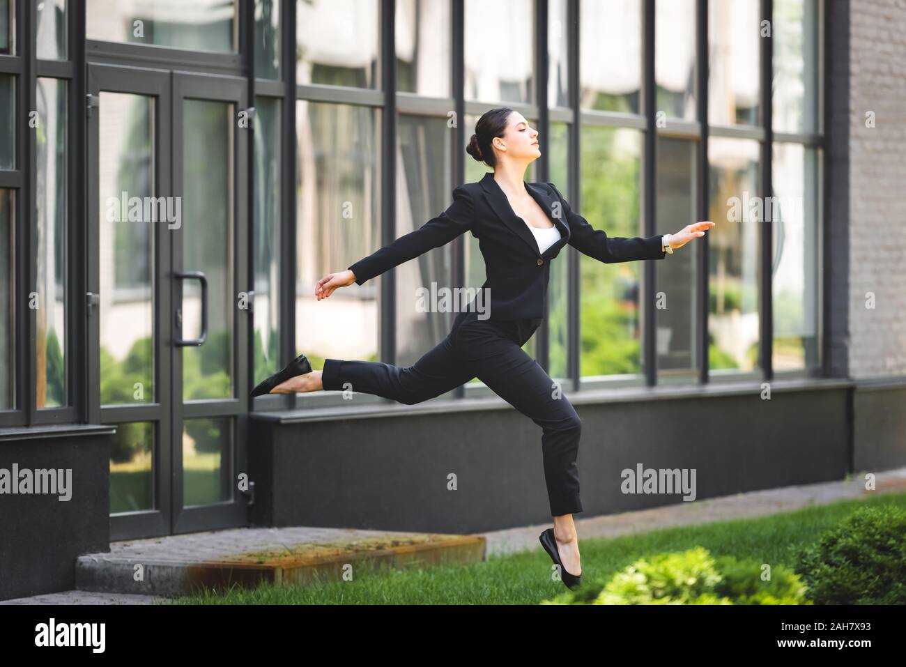 beautiful, graceful businesswoman levitating near office building Stock ...