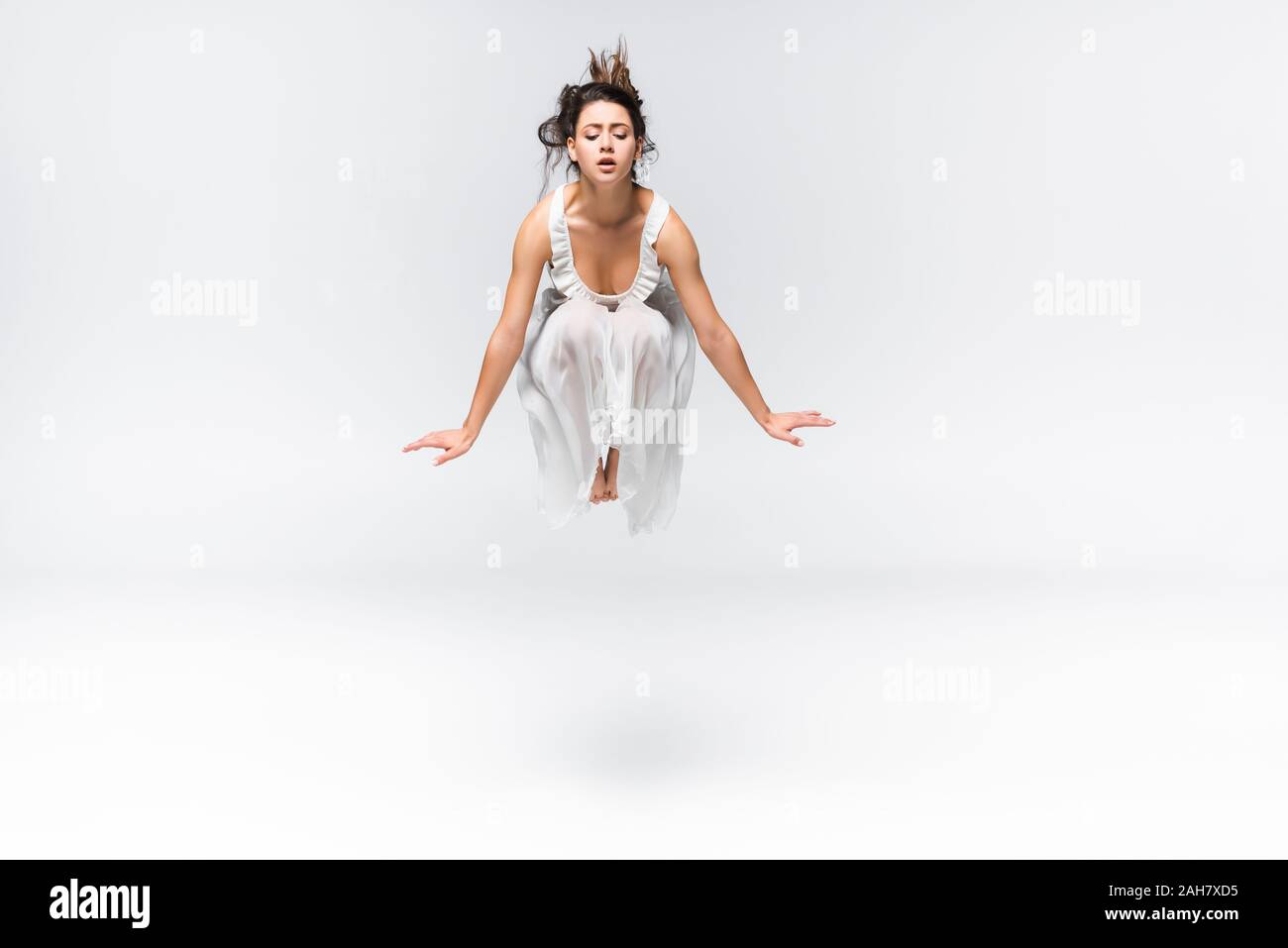 beautiful young ballerina jumping in dance on grey background Stock ...