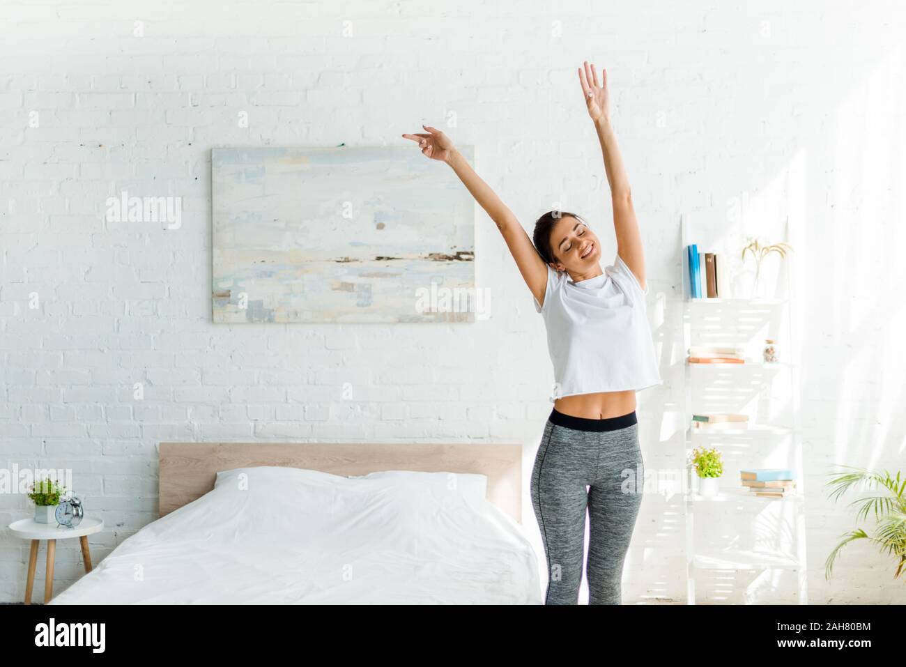 beautiful happy girl doing morning exercise in bedroom Stock Photo - Alamy