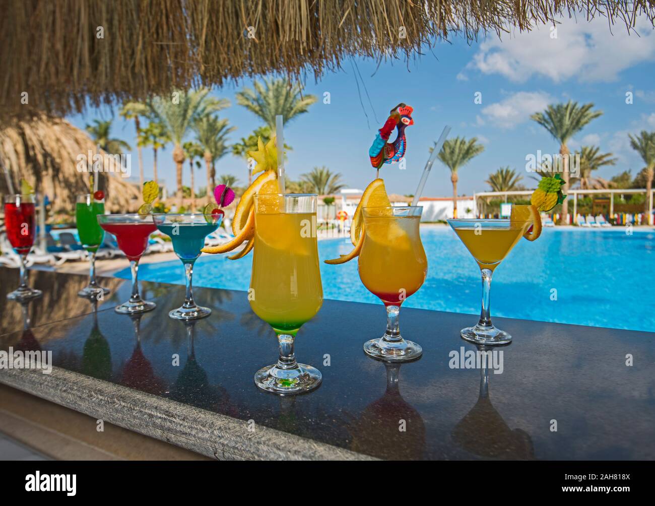 Several cocktail drinks by a tropical resort swimming pool Stock Photo ...